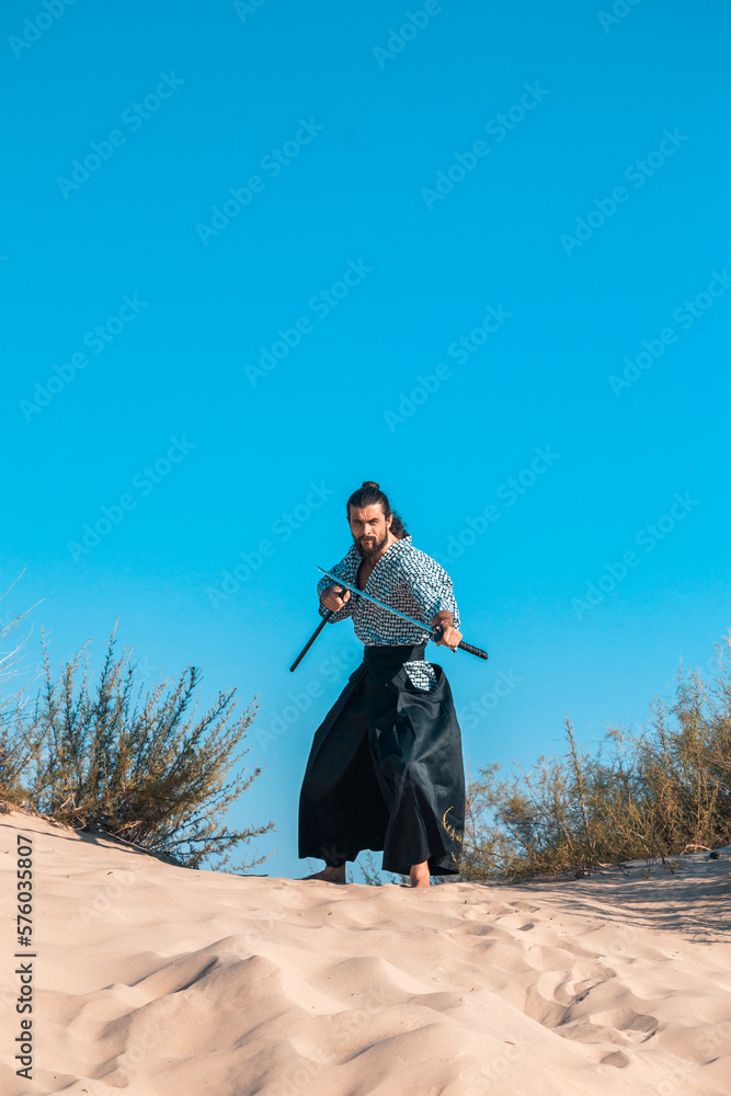 A Japanese warrior in a traditional kimano armed with a katana sword on ...
