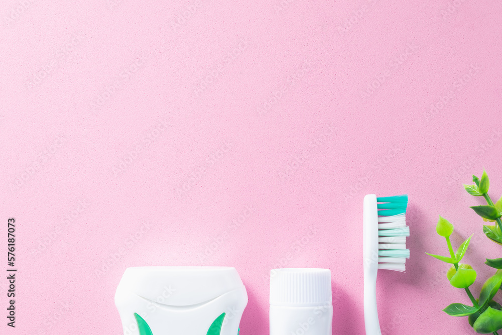 Pastel pink background with cleaning tools for oral and dental health ...