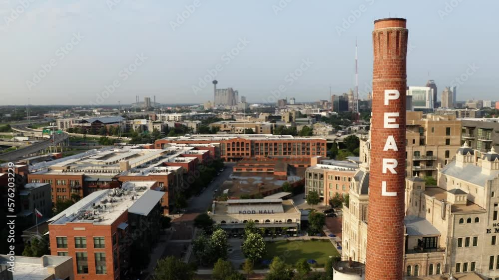 San Antonio Pearl District aerial orbit of brick pearl tower, pan right ...