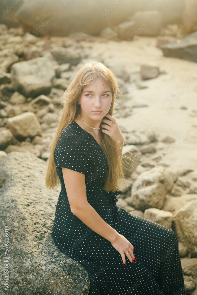 Beautiful young model girl posing at the tropical beach in long black ...