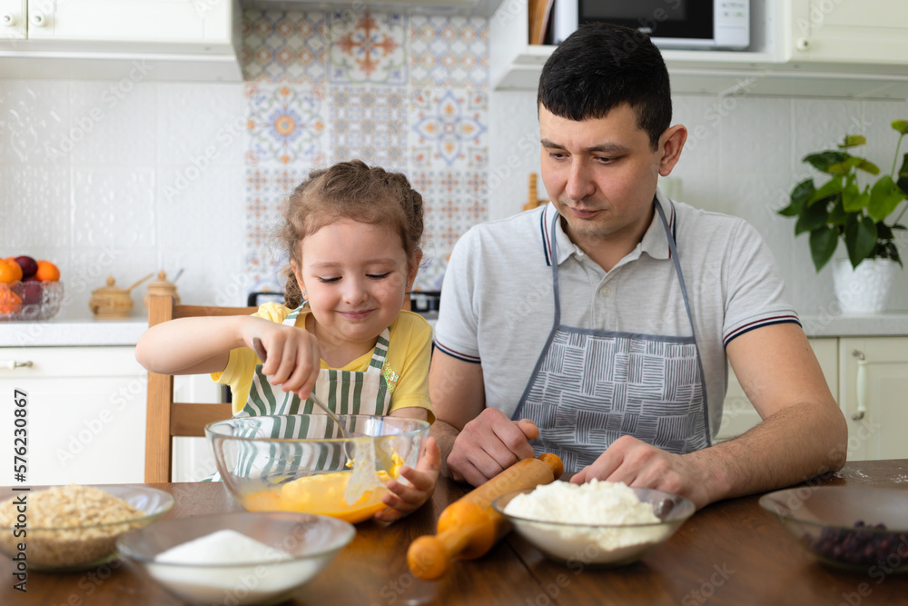child helping to father in kitchen. kid cooking food with dad. little ...