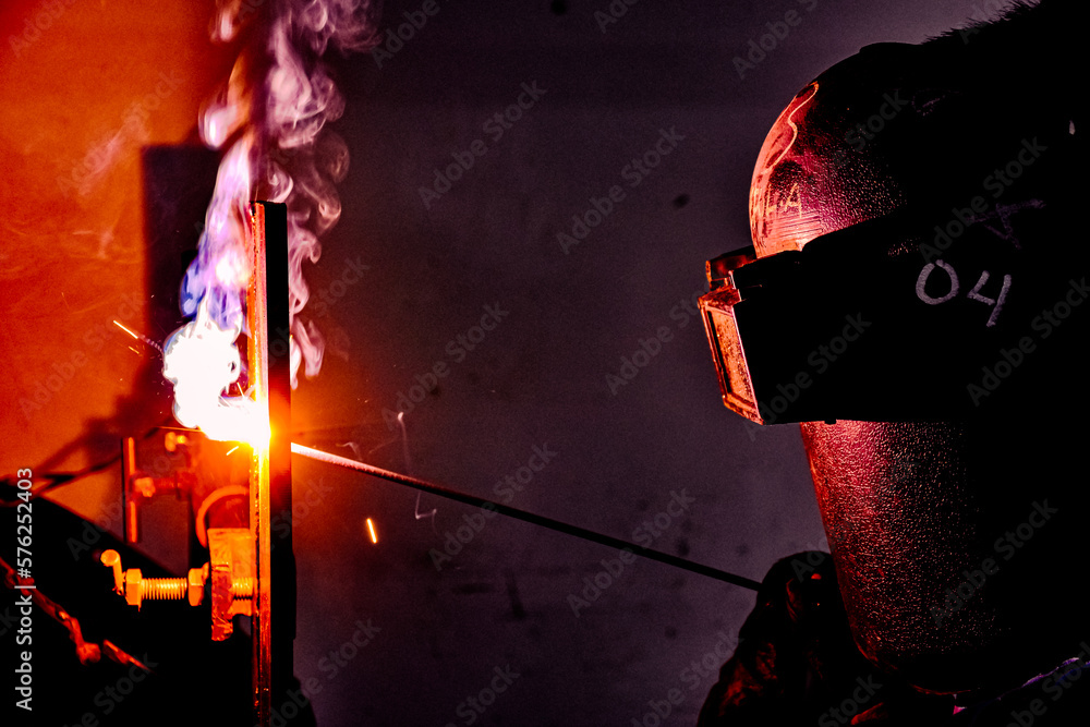 Medium perpendicular view from the side of welding process with orange ...