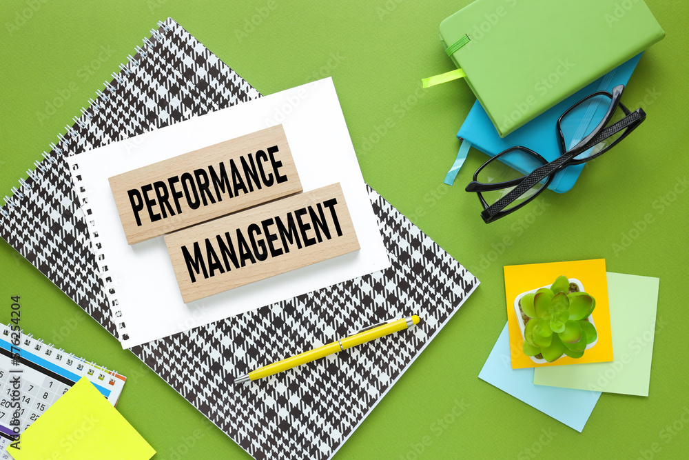 Performance Management. green background. text on paper. green and blue ...