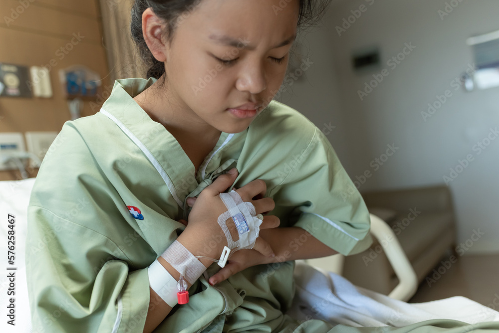 teenager sick and in pain and uses his hands to squeeze his chest chest ...