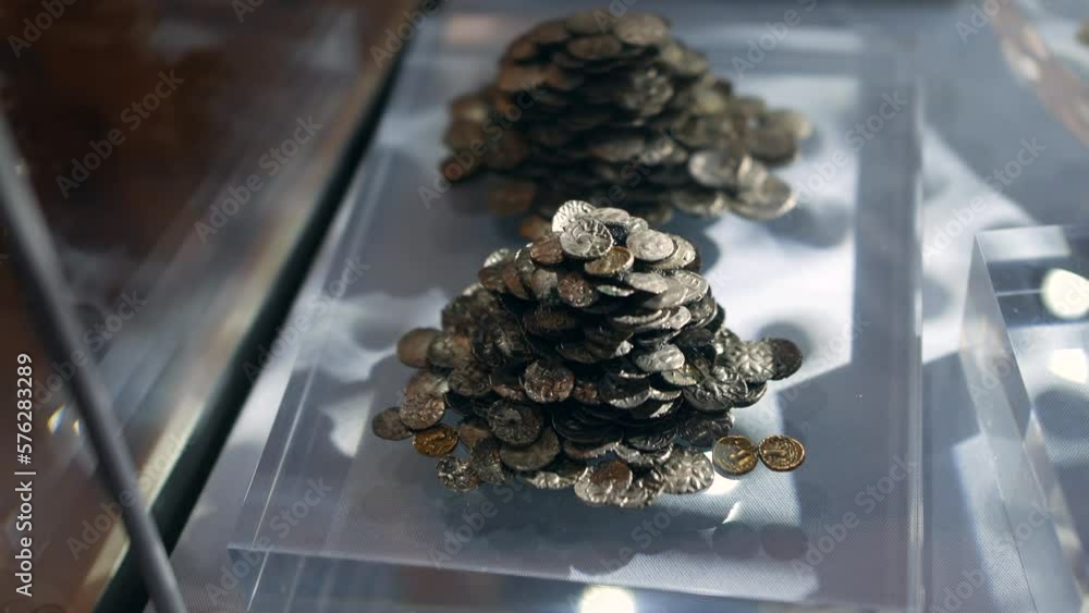A pile of Roman coins on display in a museum vídeo do Stock | Adobe Stock