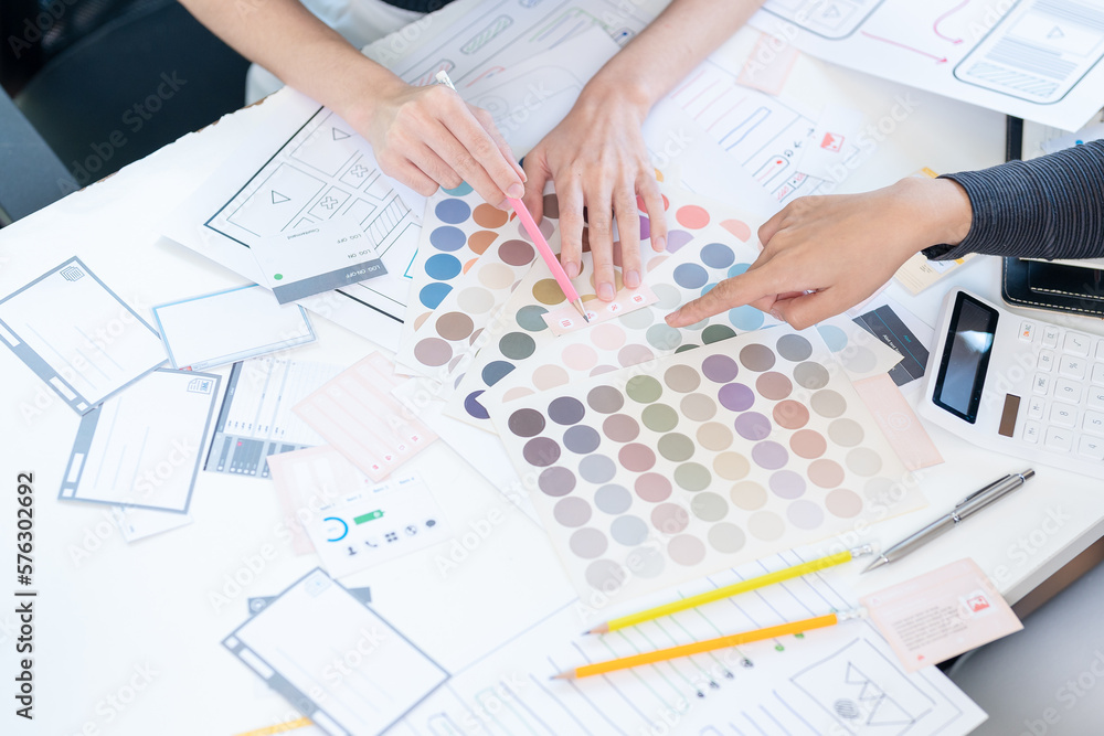 Two Young and beautiful creative female designer making a sketch while ...