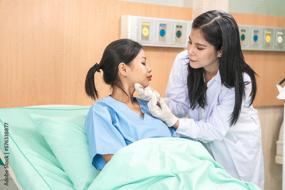 Beautiful white female doctor, dermatologist, touches patient's face ...
