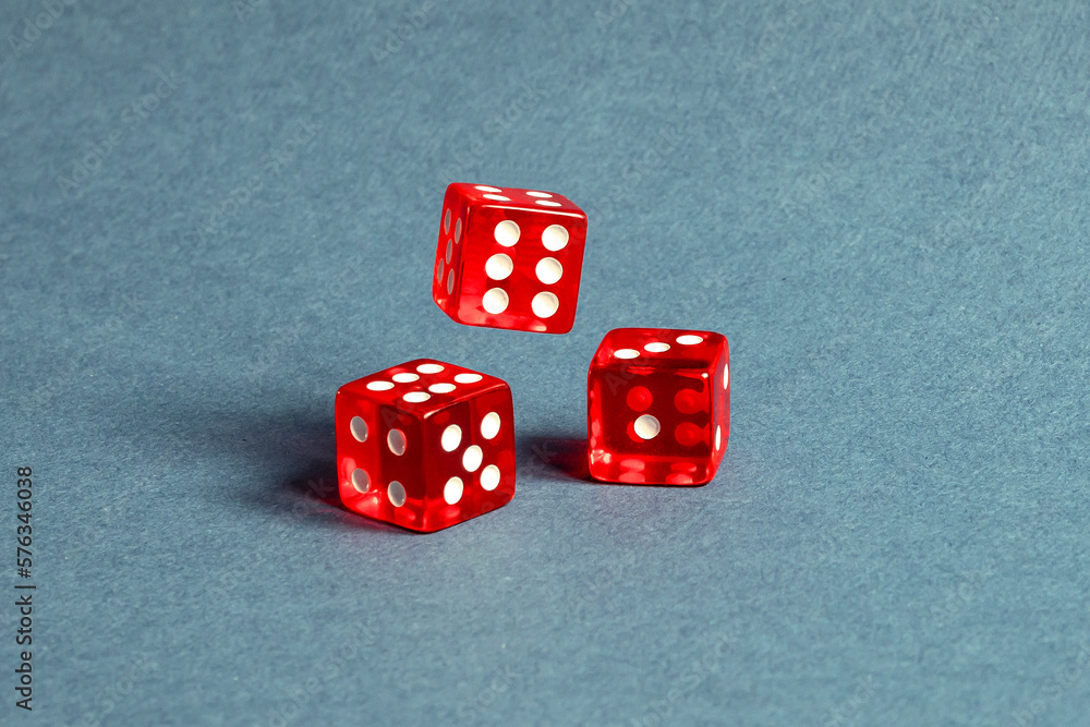 Random number generator. Three red dice with numerical values lie in a ...