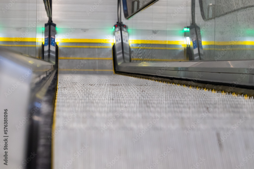 Escalators in an underground pedestrian passage. Close-up of steps ...