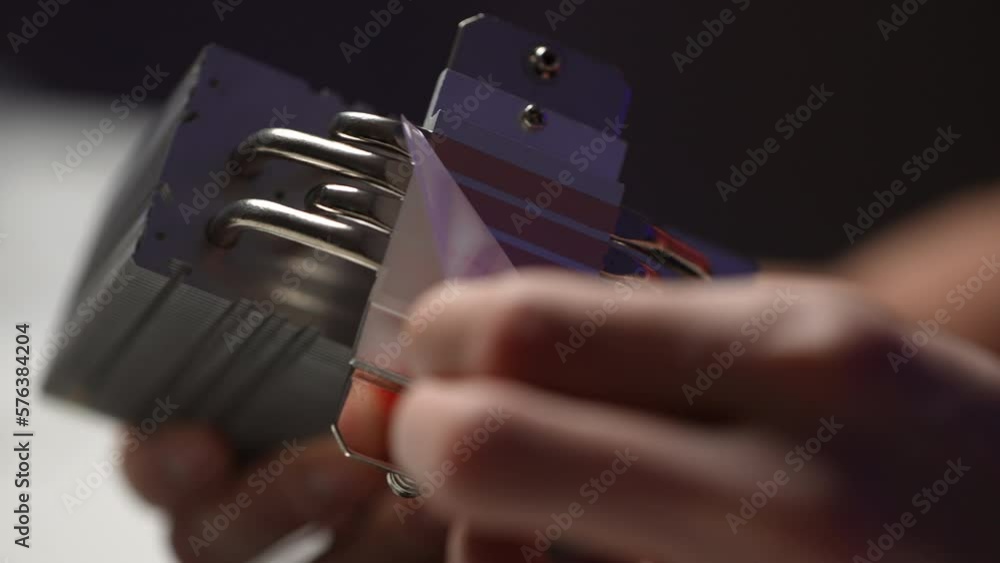 Close-up hands of unrecognizable man removing warning sticker from new ...