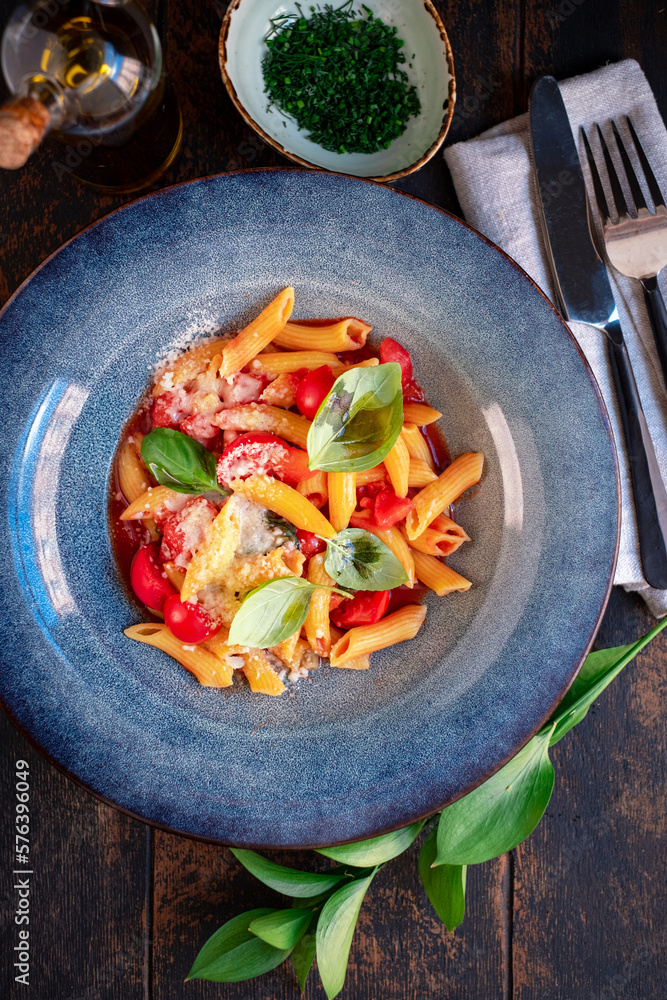 Penne pasta with tomatoes, parmesan and basil. Italian dish Pasta al ...