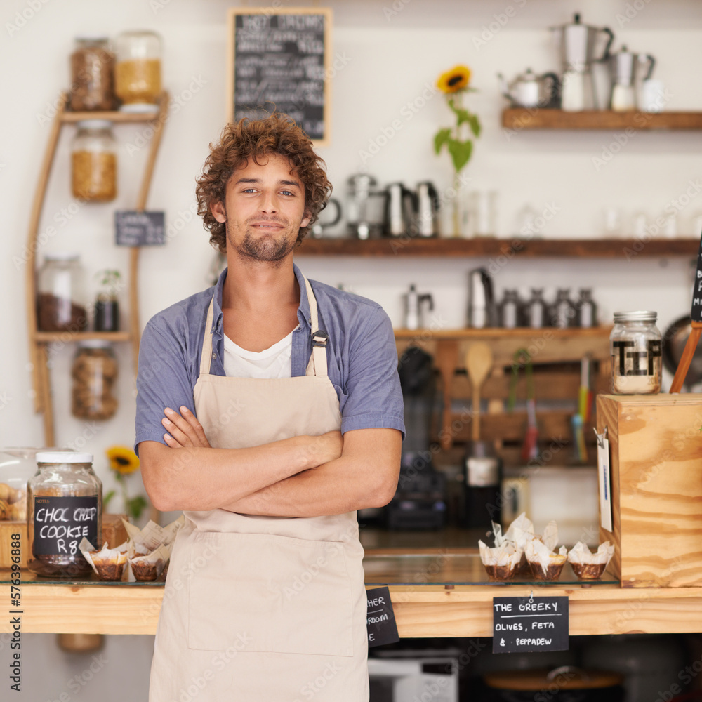 Always a friendly face at the cafe. Portrait of a male barista standing ...