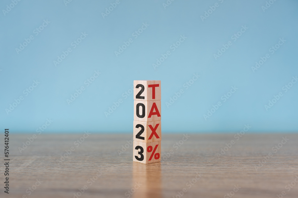 Tax and 2023 number on wooden block. Pay tax in 2023 years. The new ...