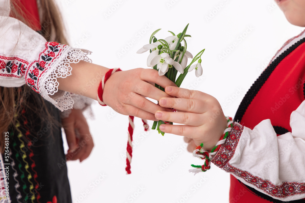 Hands of bulgarian kids boy and girl in traditional ethnic costumes ...