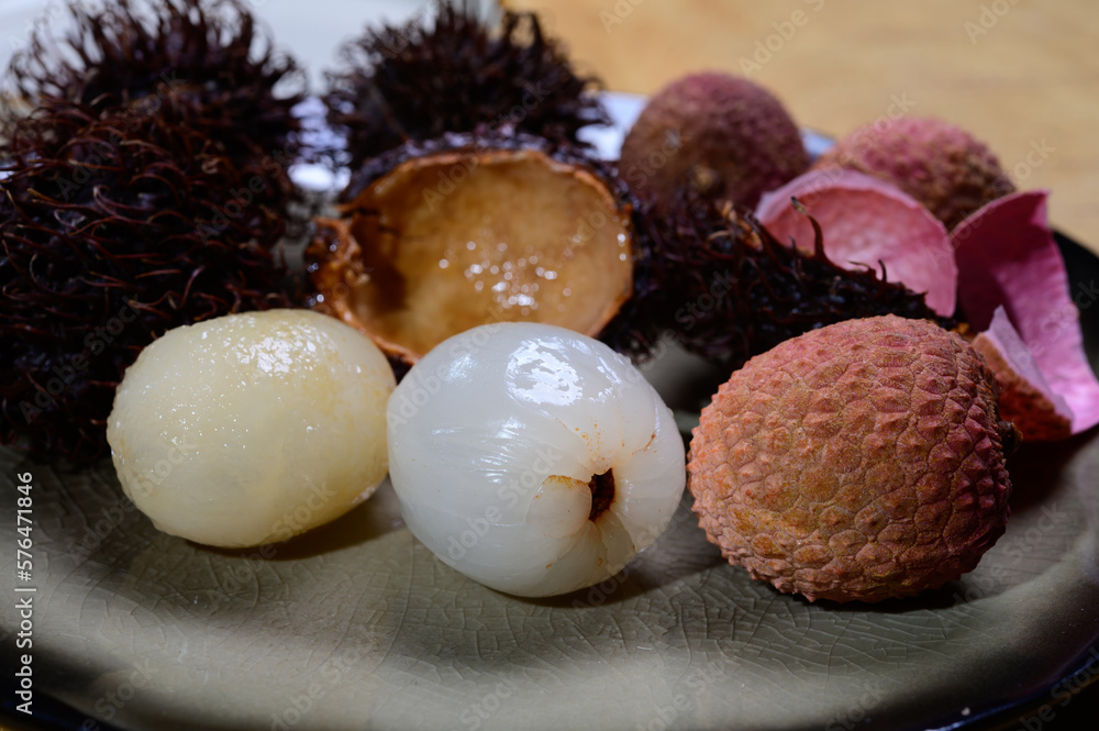 Foto de Tasty tropical exotic fruits, ripe fresh peeled and unpeeled ...