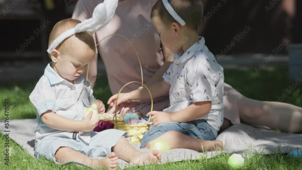 Easter holiday outdoor family mother children sitting spring grass ...