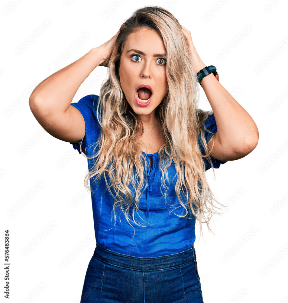 Young blonde woman wearing casual clothes crazy and scared with hands ...