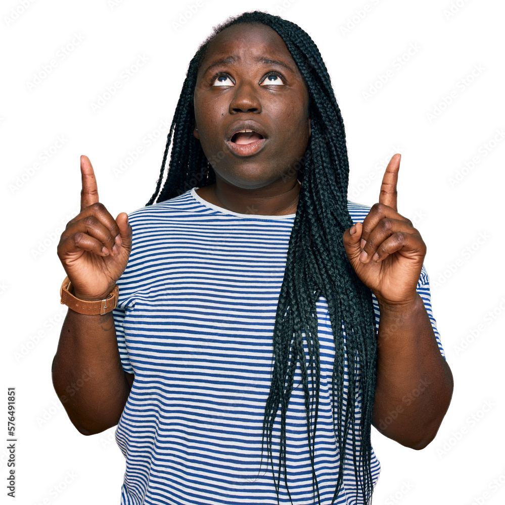 Young black woman with braids wearing casual clothes amazed and ...