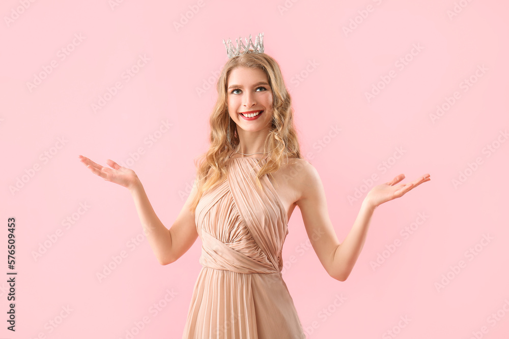 Teenage girl in crown and prom dress on pink background Stock Photo ...