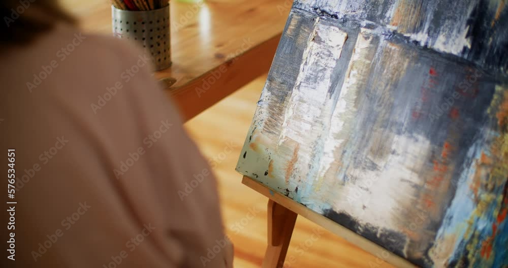 Unrecognizable talented woman painter paints oil with spatula on canvas ...