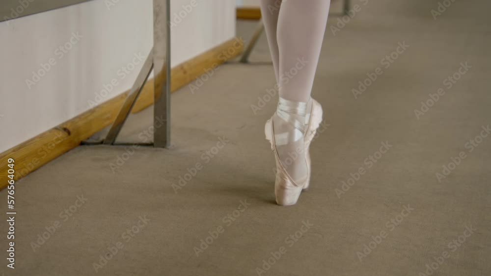 Professional ballerina in training suit dancing on tiptoe in pointe ...