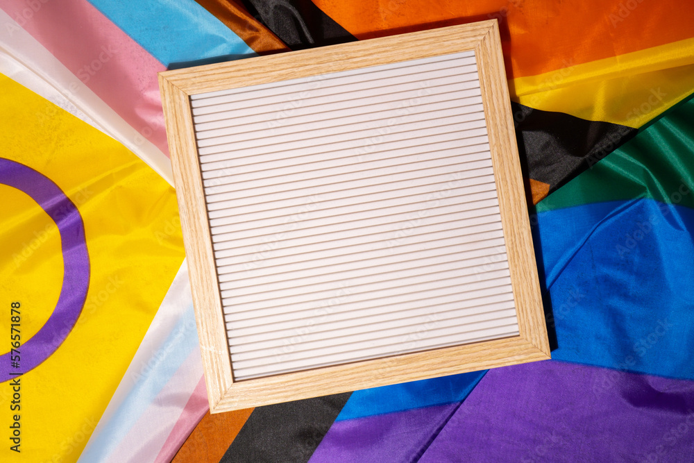 Empty blank frame on Rainbow LGBTQIA flag made from silk material with ...