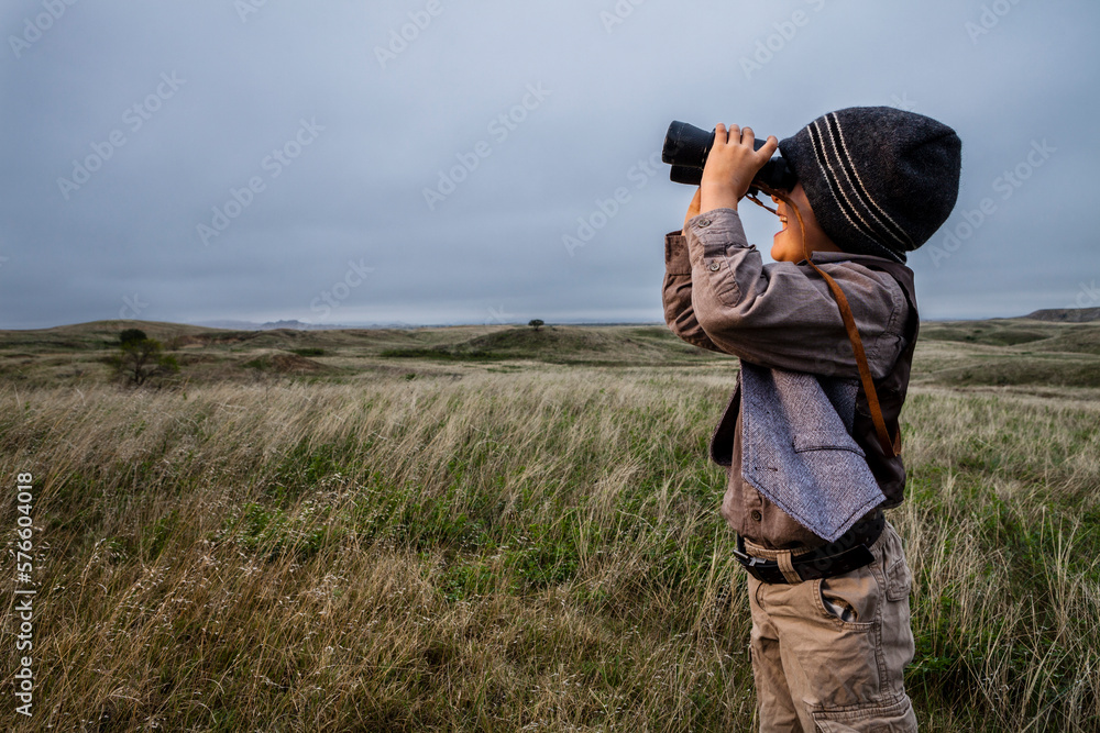 Boy wearing explorer costume holding binoculars Stock Photo | Adobe Stock