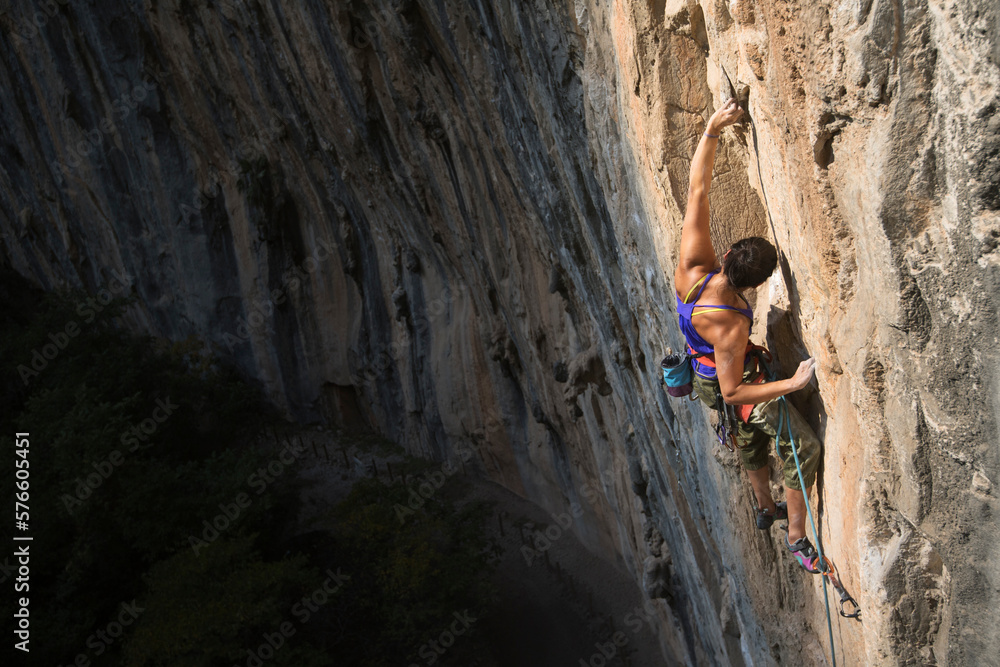Female rock climber during ascent at El Salto climbing area, Nuevo Leon ...