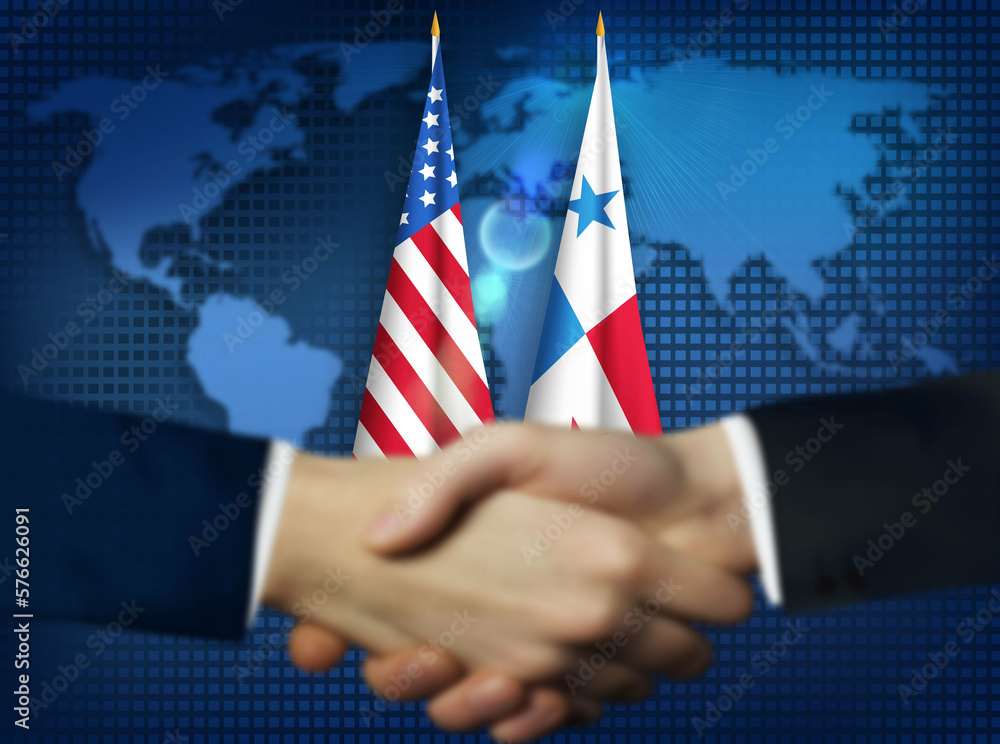Two people shaking hands in front of American, and Panama flags.Panama, US bilateral relation ...