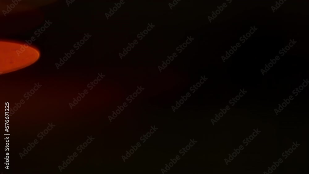 Anamorphic orange flare bokeh blinking on black background for overlay ...