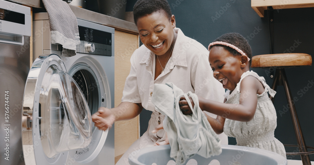 Laundry, mother and child helping with folding of clothes together in a ...