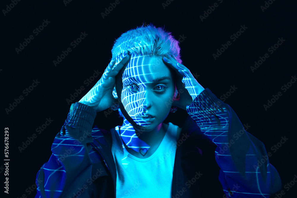 Virtual reality. Portrait of young blonde girl with neon holographic ...