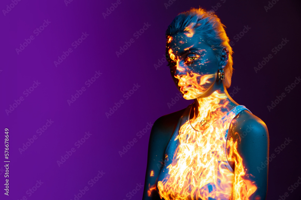 Robot. Portrait of young blonde girl with digital burning fire on body ...