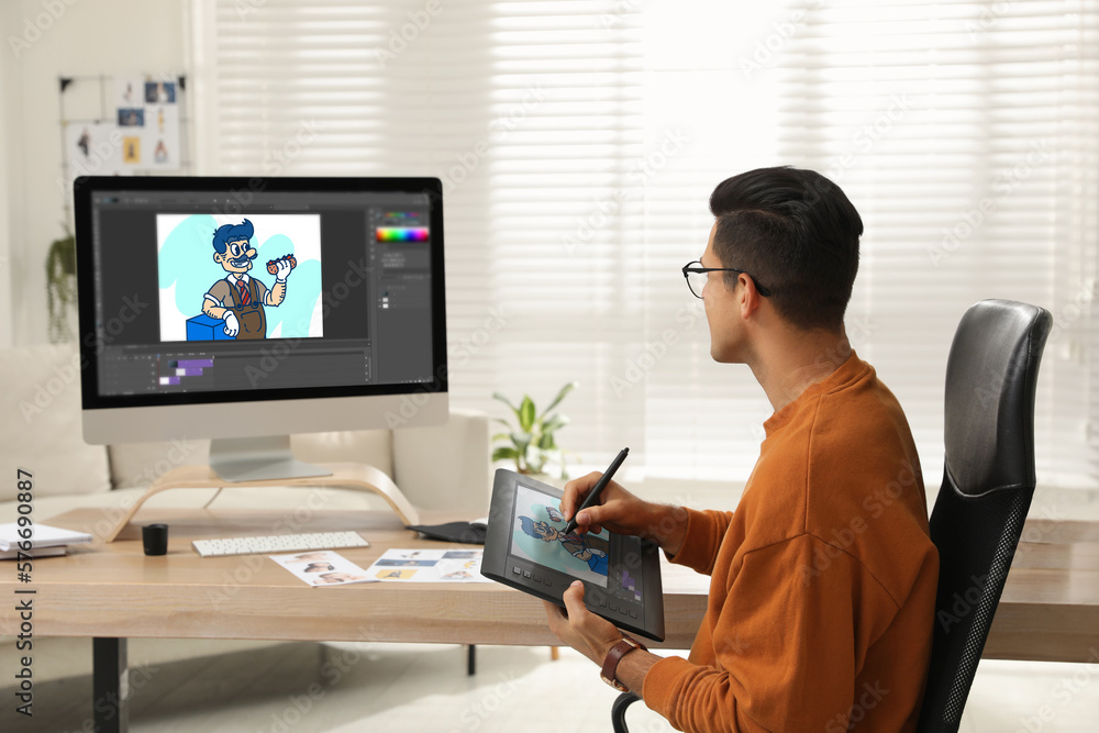 Animator using graphic tablet and computer. Illustration on screens ...