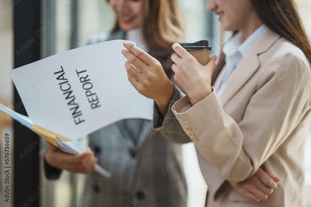 Financial analysts analyzing business reports on planned investment ...