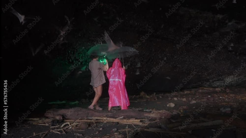 Two female persons exploring a bat cave. Anime style footage of ...