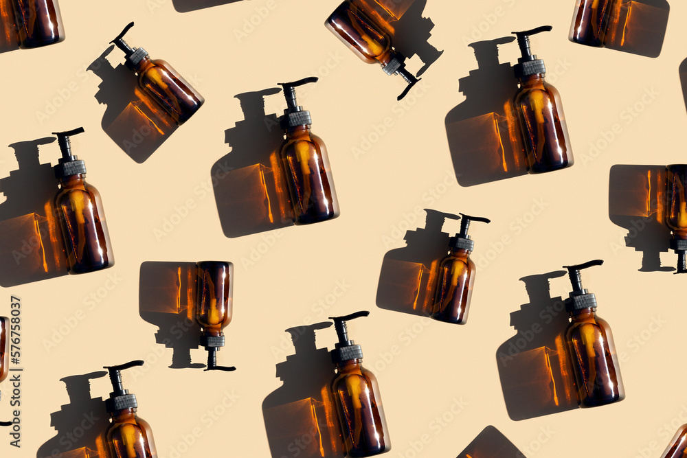 Pattern made with brown glass bottle with pump of cosmetic products and ...