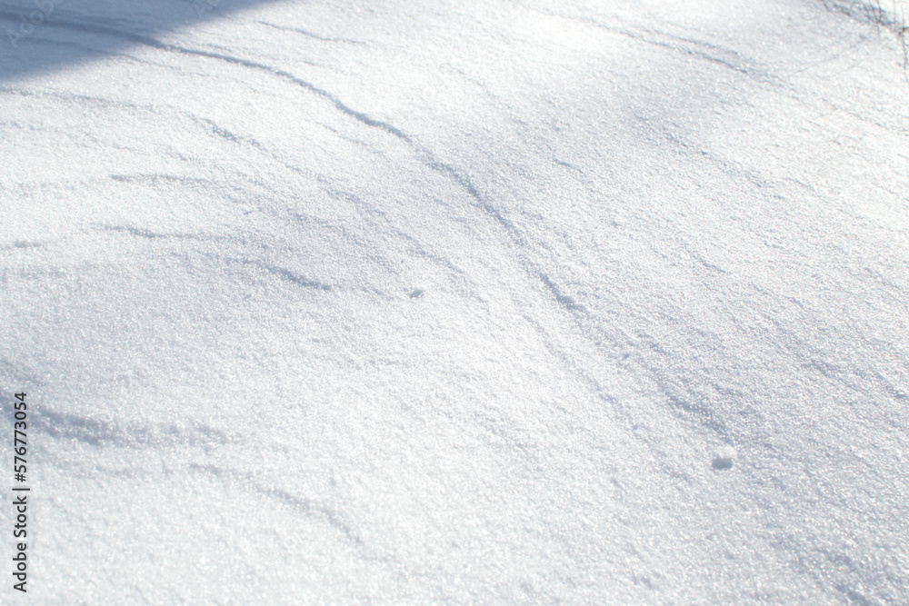 winter background with snowy ground. Wind sculpted patterns on snow ...