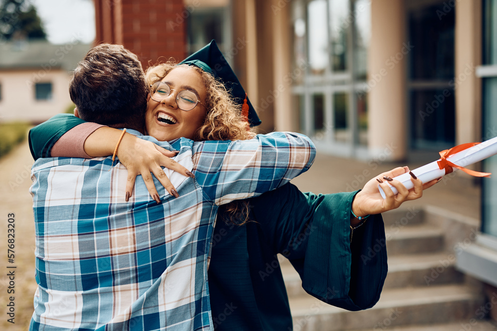 Supportive father congratulates his graduate daughter after receiving ...