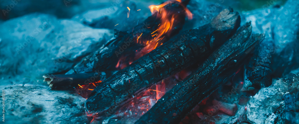 Vivid smoldered firewoods burned in fire close-up. Atmospheric warm ...