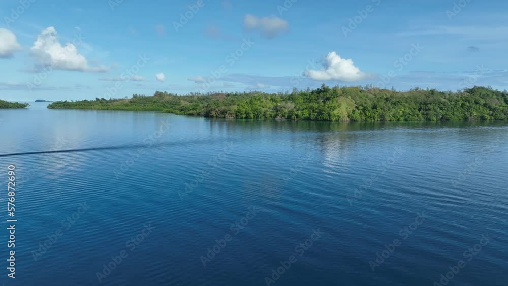 Shallow coral reefs surround a remote island in the Solomon Islands ...