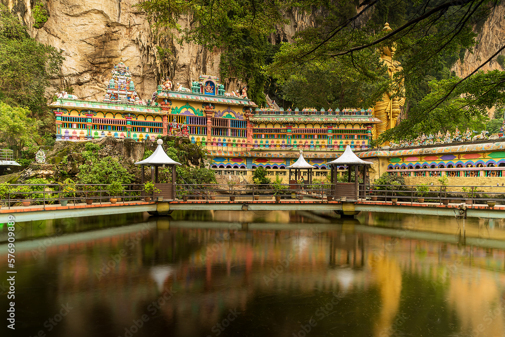 Hindu temple with colorful decorations. There are narrow bridges and a ...