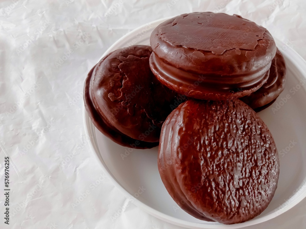 cake consisting of two layers of small round chocolate cookies with ...