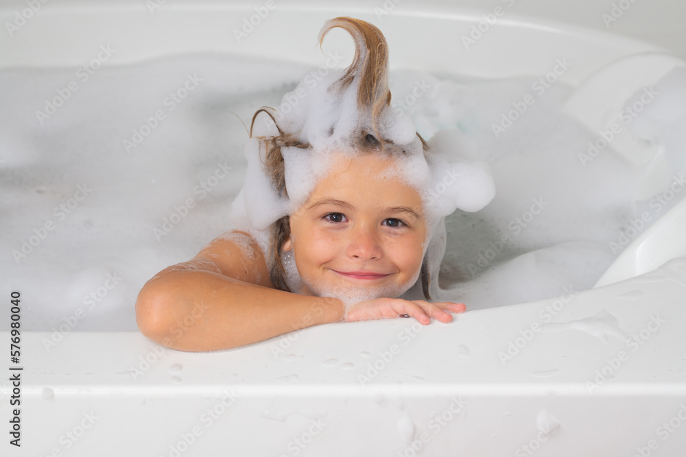 Kids bath. Kid washing with a bubbles in bath. Cute child bathes, lying ...