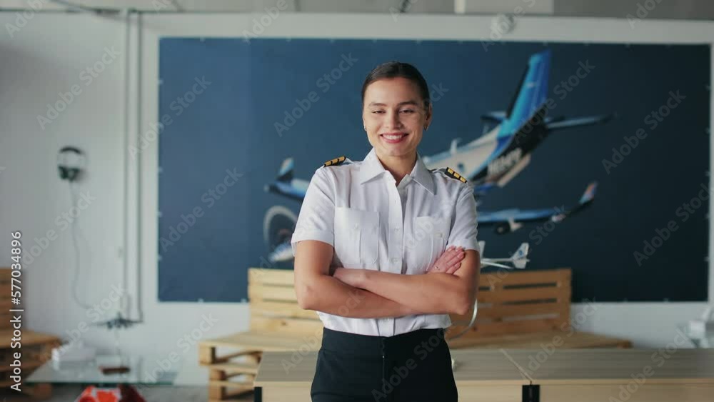 Front view of female instructor, pilot standing in classroom, looking ...