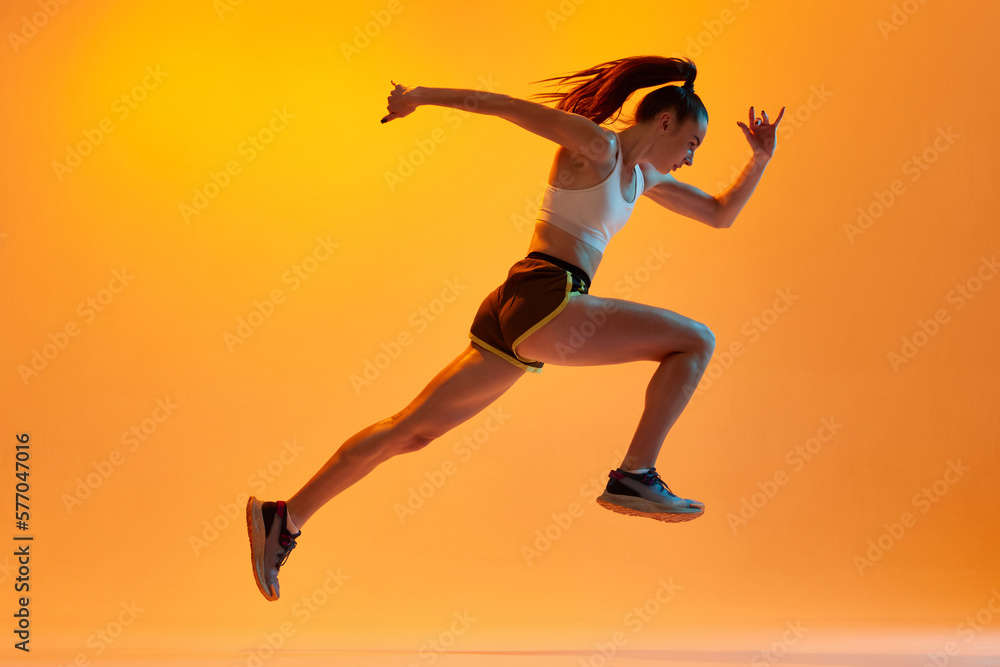 Speed. Dynamic image of young girl, professional athlete, runner in ...