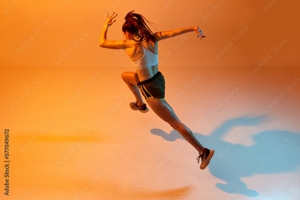 Top side view dynamic image of professional female runner, athlete ...