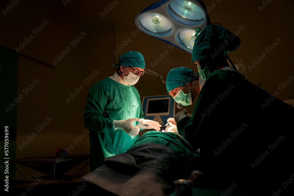 Team doctors in operating room dressed green uniforms saving lives ...