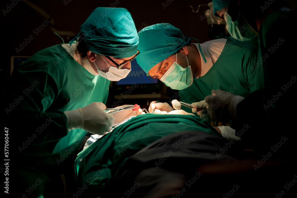 Team doctors in operating room dressed green uniforms saving lives ...