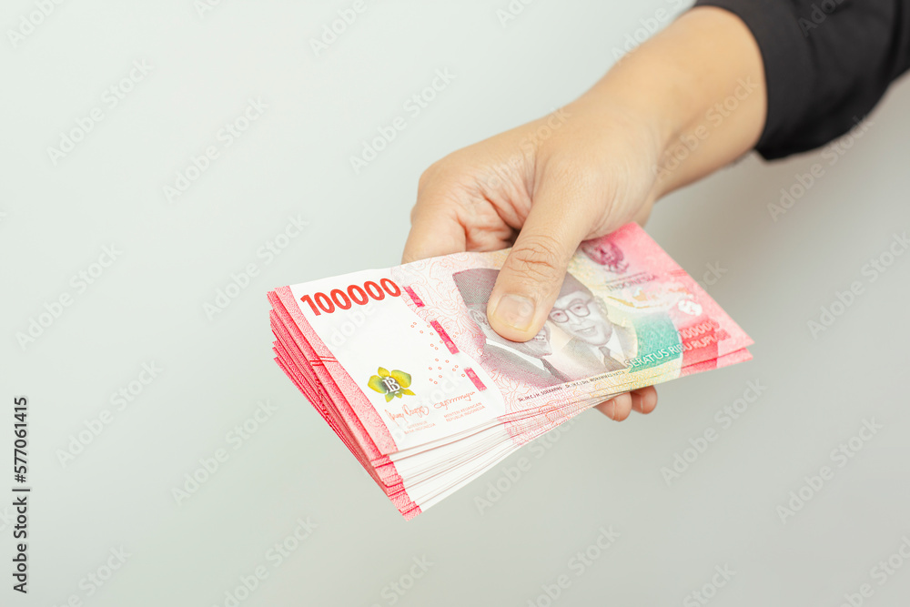 Cash payment concept. Indonesian rupiah currency (Rp. 100.000 Seratus ...
